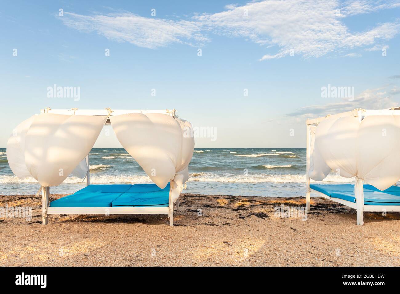 Scenic view empty white beach wooden canopies cabanas with white ...