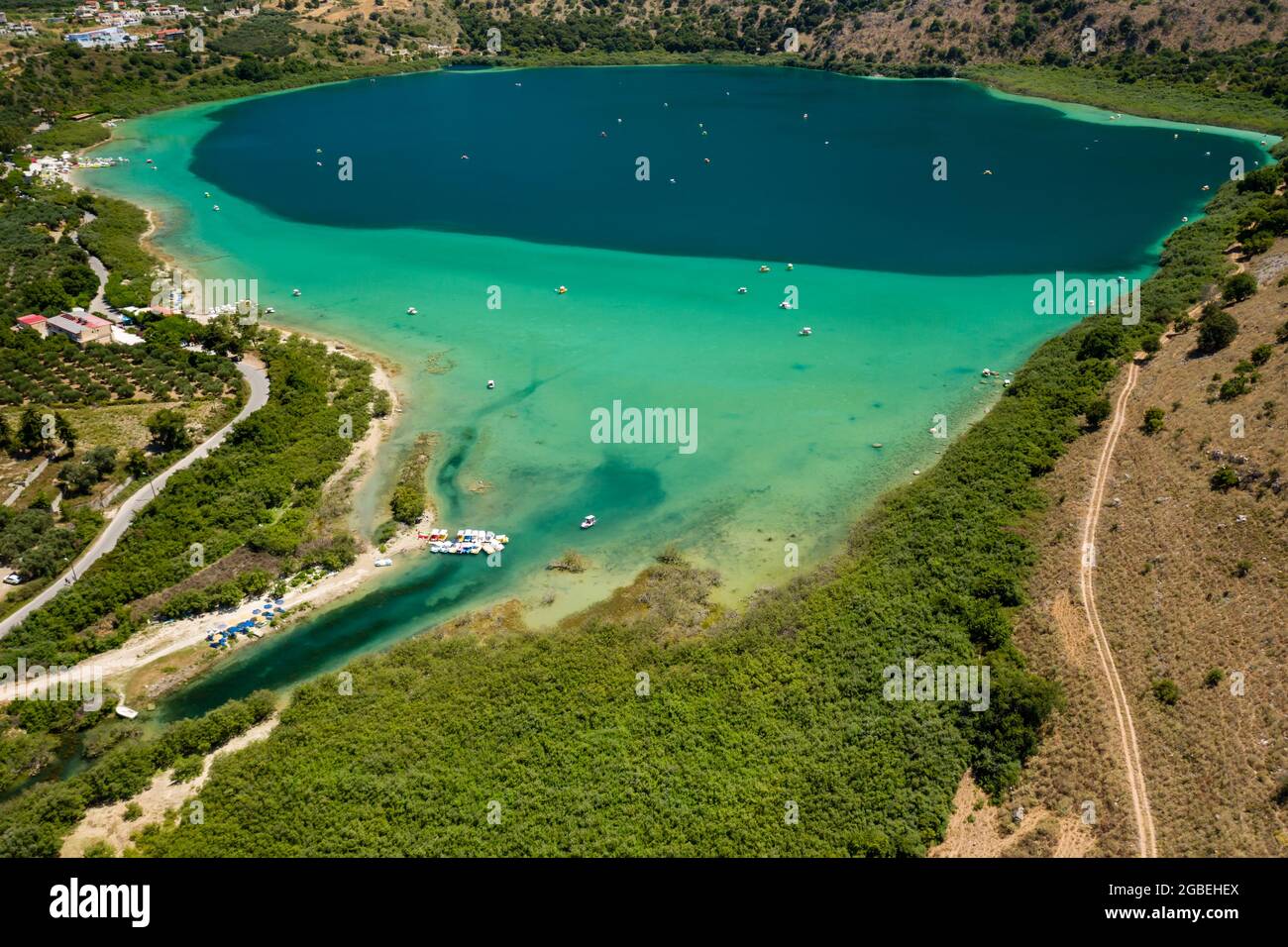 Aerial view of a huge freshwater lake surrounded by tall mountains ...
