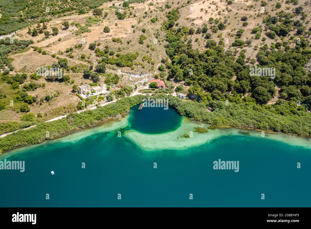 Aerial view of a huge freshwater lake surrounded by tall mountains ...