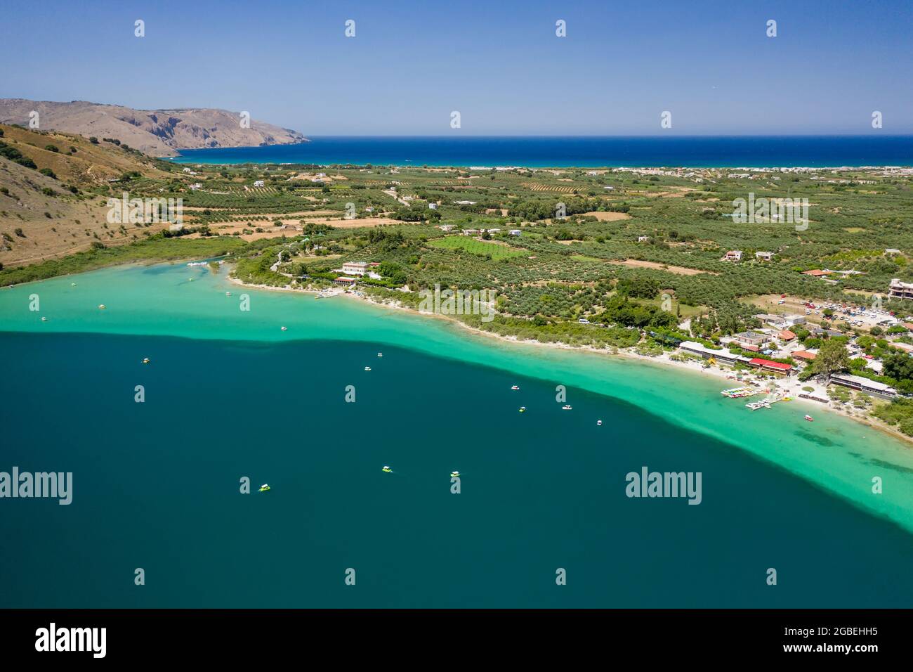 Aerial view of a huge freshwater lake surrounded by tall mountains ...
