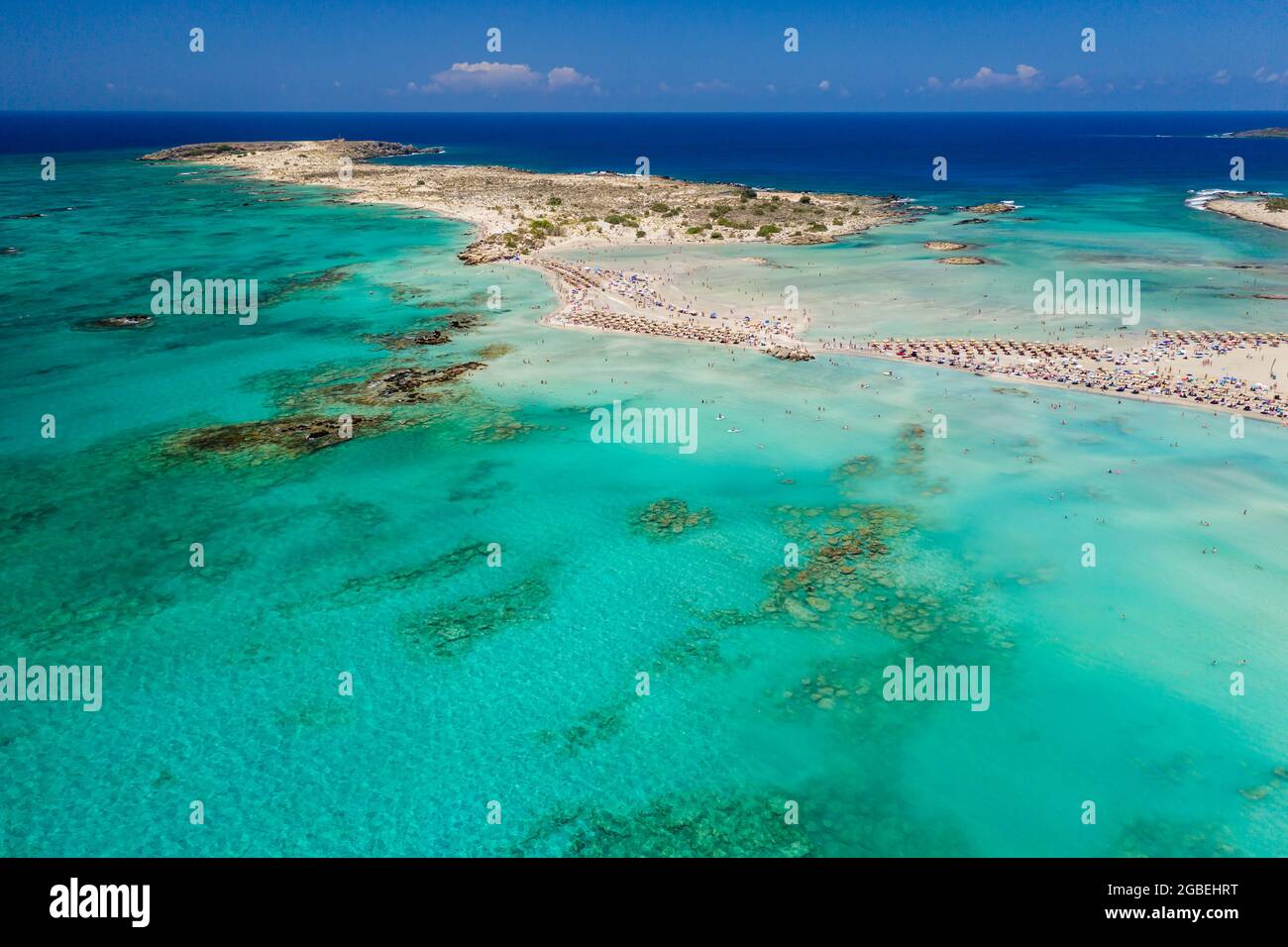 Aerial view of shallow sandy lagoons and a beach surrounded by deeper ...