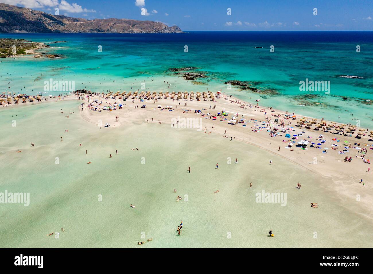 Aerial view of shallow sandy lagoons and a beach surrounded by deeper ...