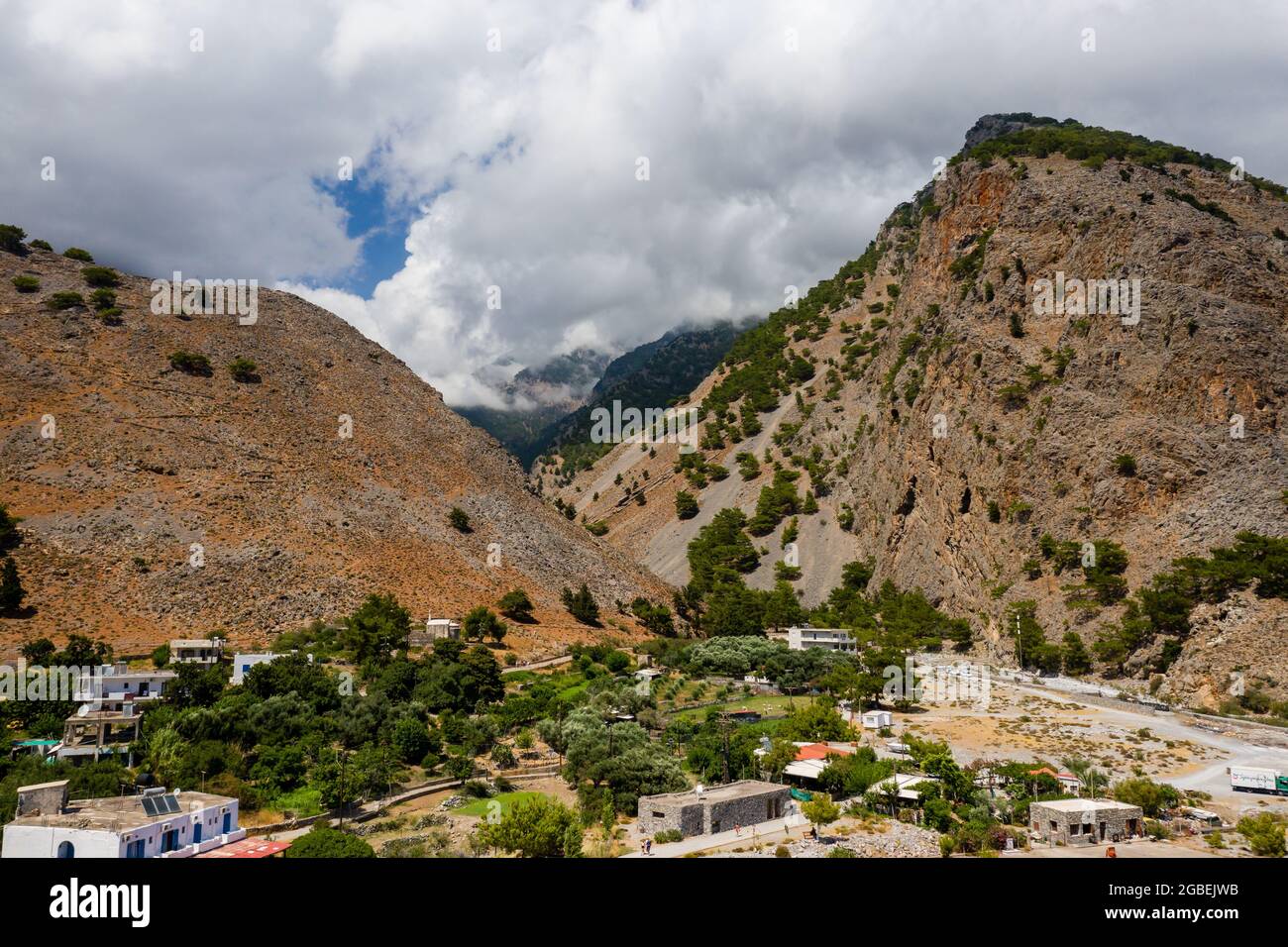 Aerial view of towering, cloud covered mountains at the exit of the ...