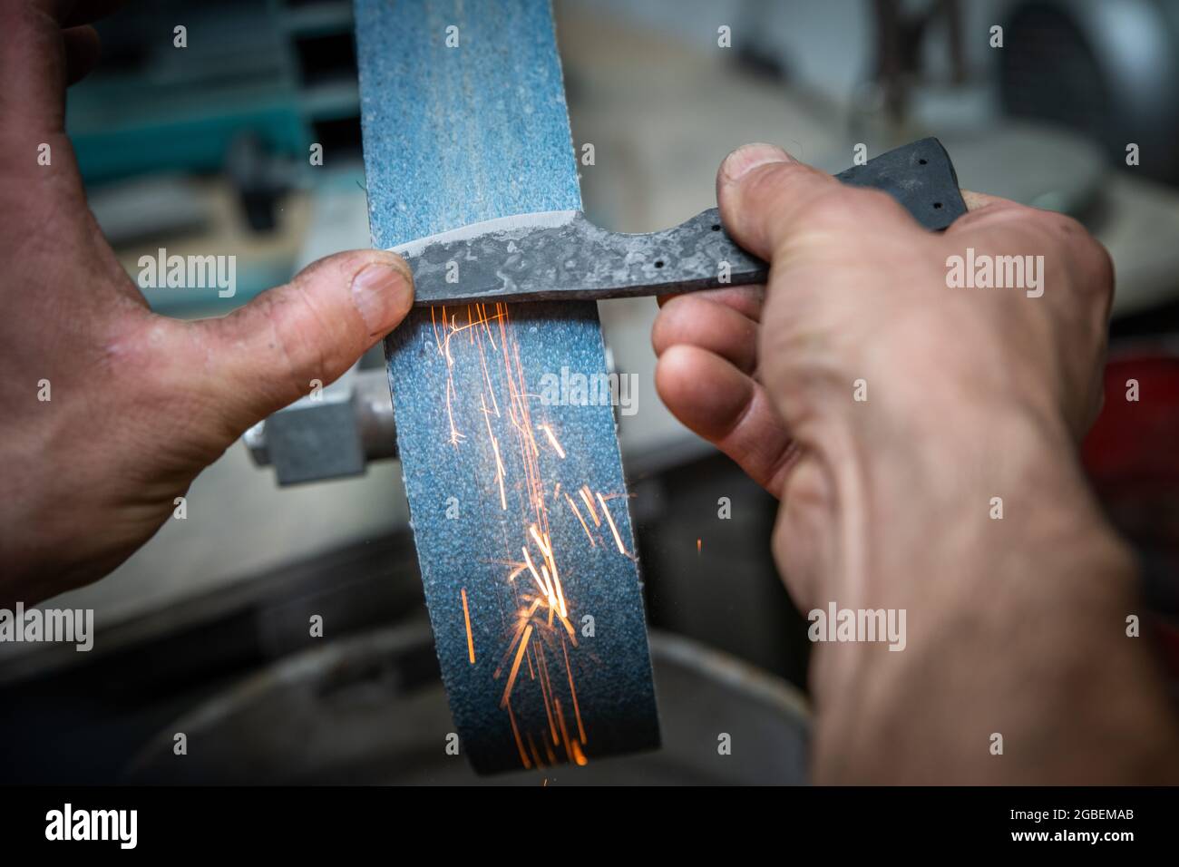 two man hands are manufacturing a steel knife Stock Photo - Alamy