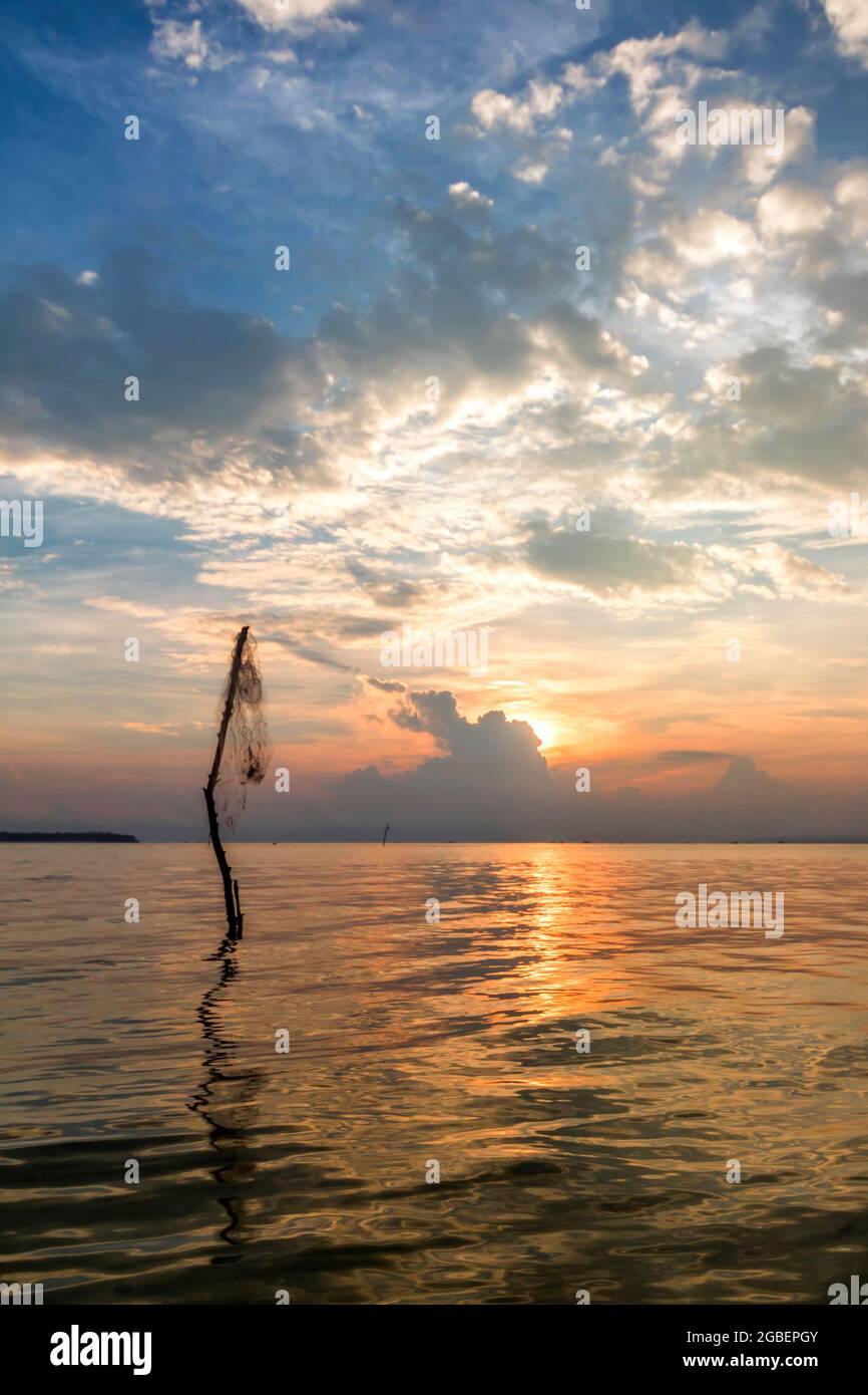 a sunset over a body of water Stock Photo - Alamy
