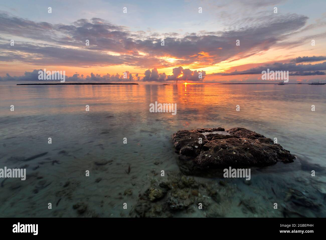 a sunset over a body of water Stock Photo - Alamy