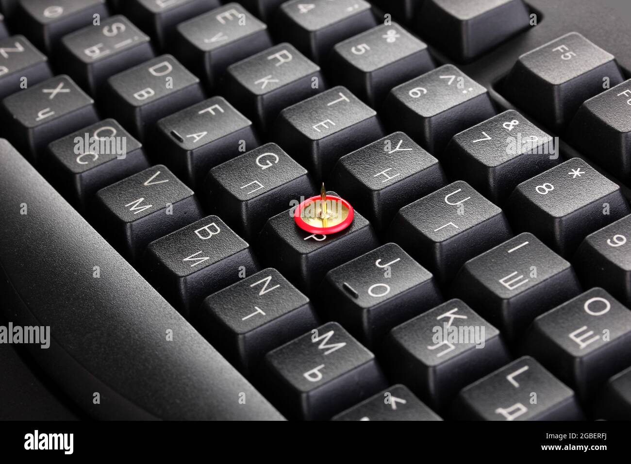 Painful typing, pin on keyboard close-up Stock Photo - Alamy