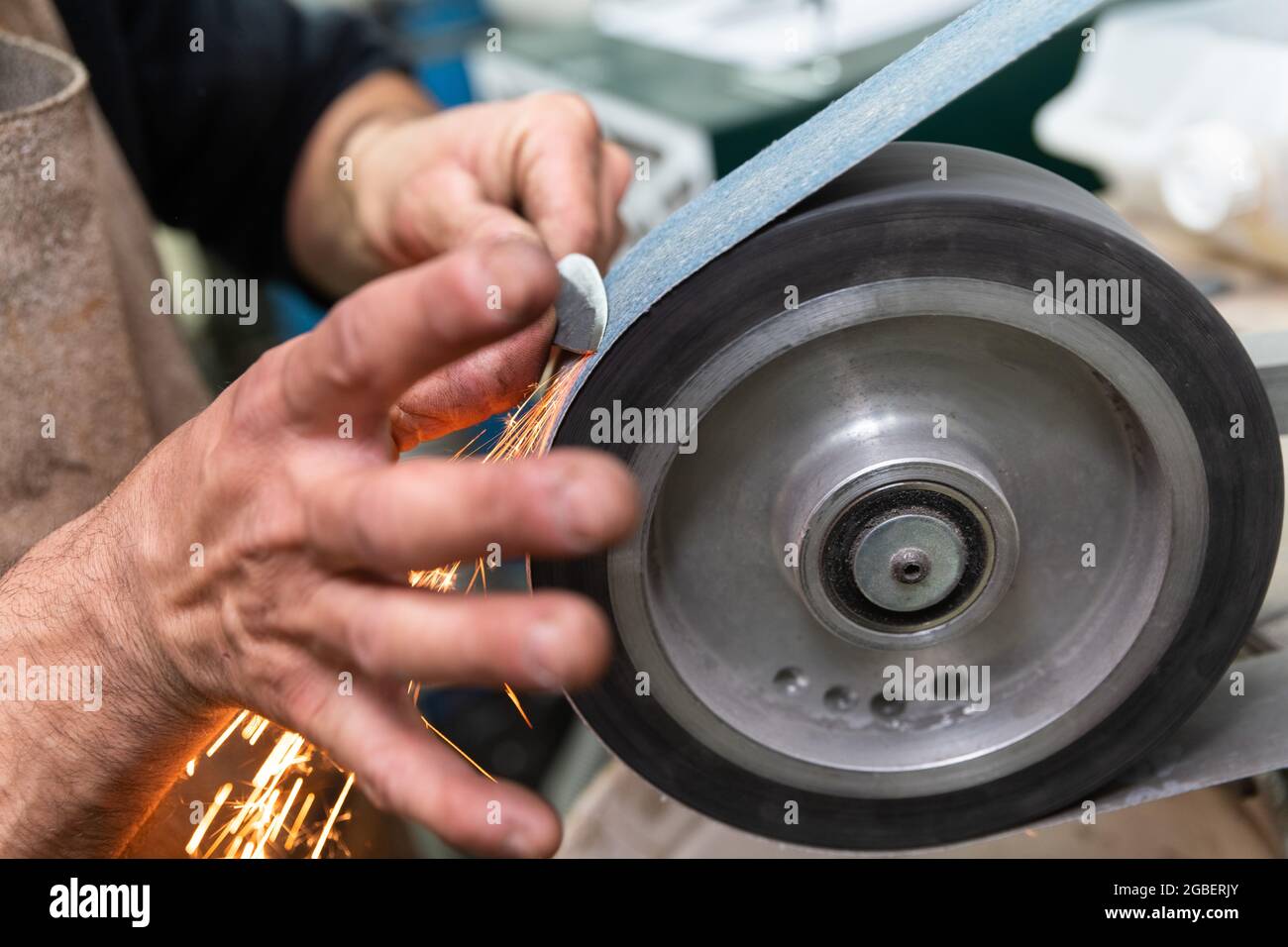 two man hands are manufacturing a steel knife Stock Photo - Alamy