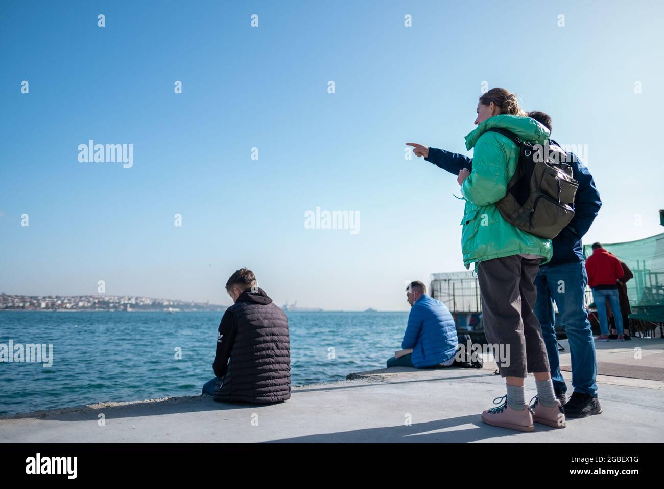 Findikli, Istanbul, Turkey - 02.26.2021: a man shows seascape to a ...