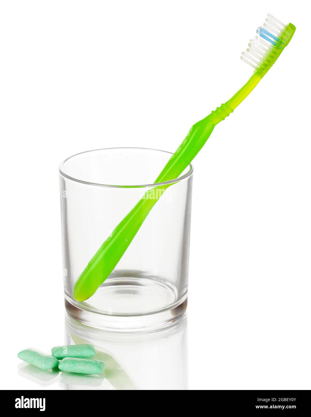 Toothbrush in glass and chewing gum isolated on white Stock Photo - Alamy