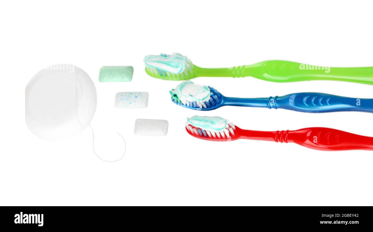 Toothbrushes, dental floss and chewing gum isolated on white Stock ...