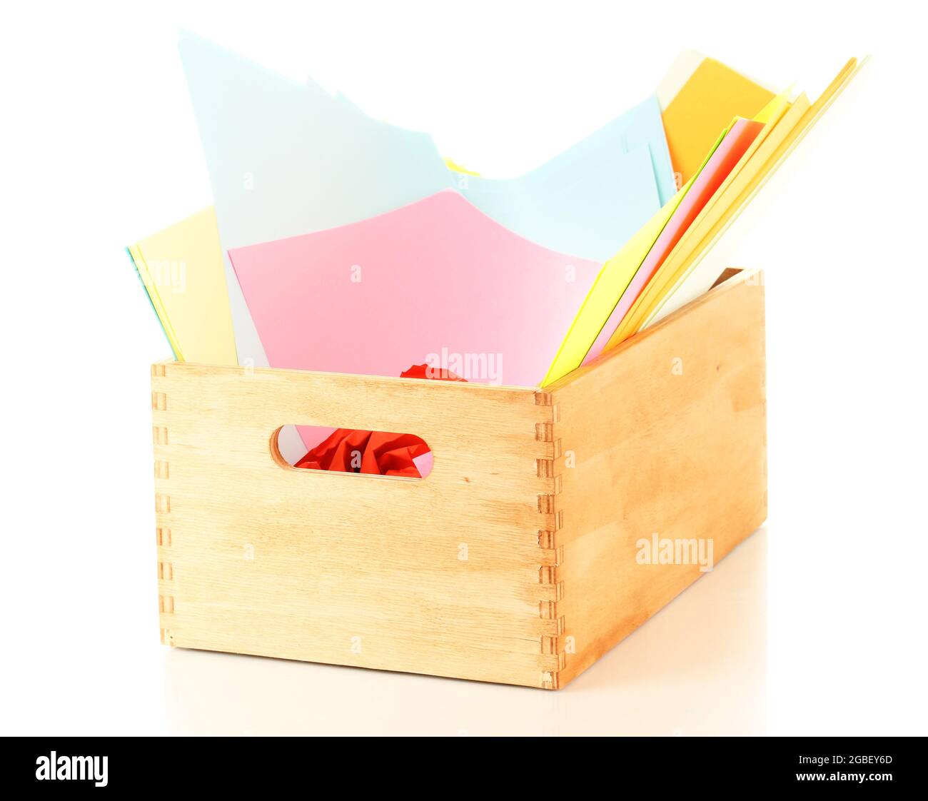 Wooden crate with colorful papers isolated on white Stock Photo - Alamy