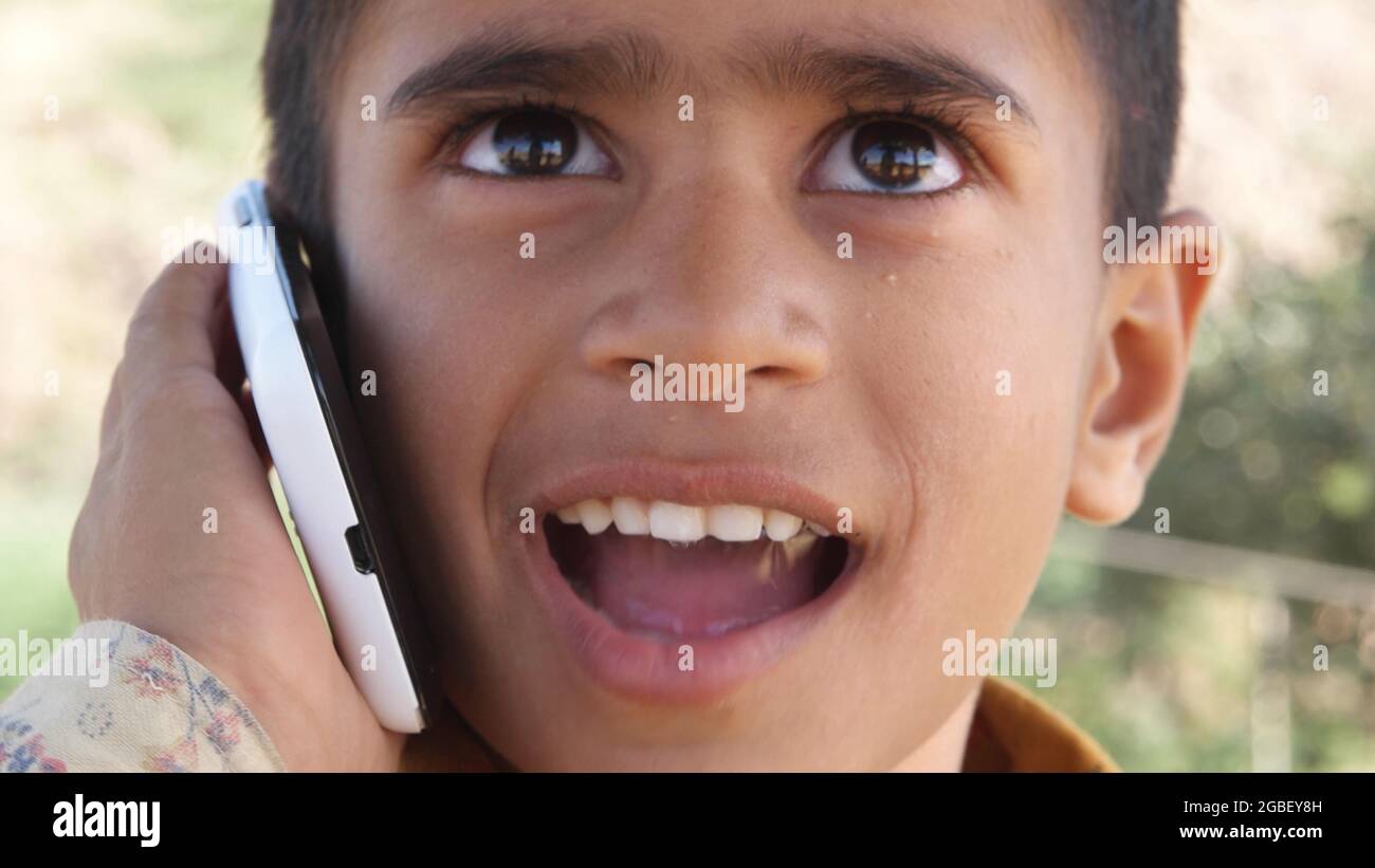 Cute happy kid talking on the phone Stock Photo - Alamy
