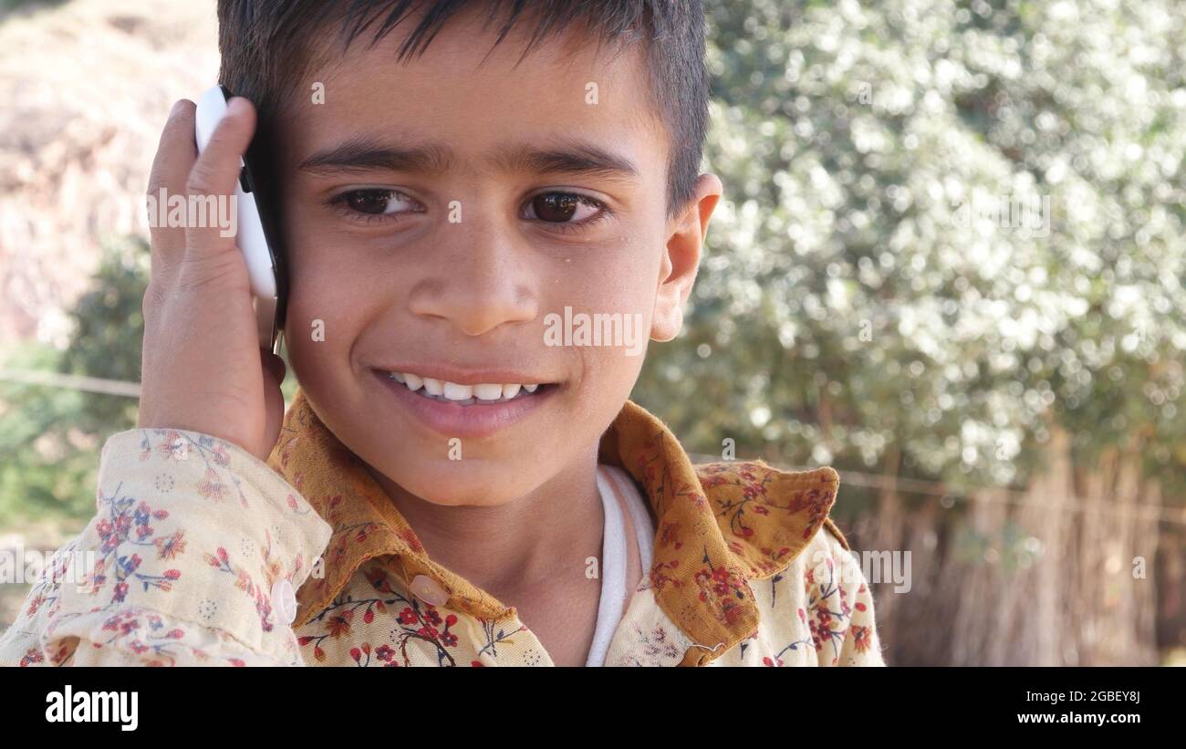 Cute happy kid talking on the phone Stock Photo - Alamy