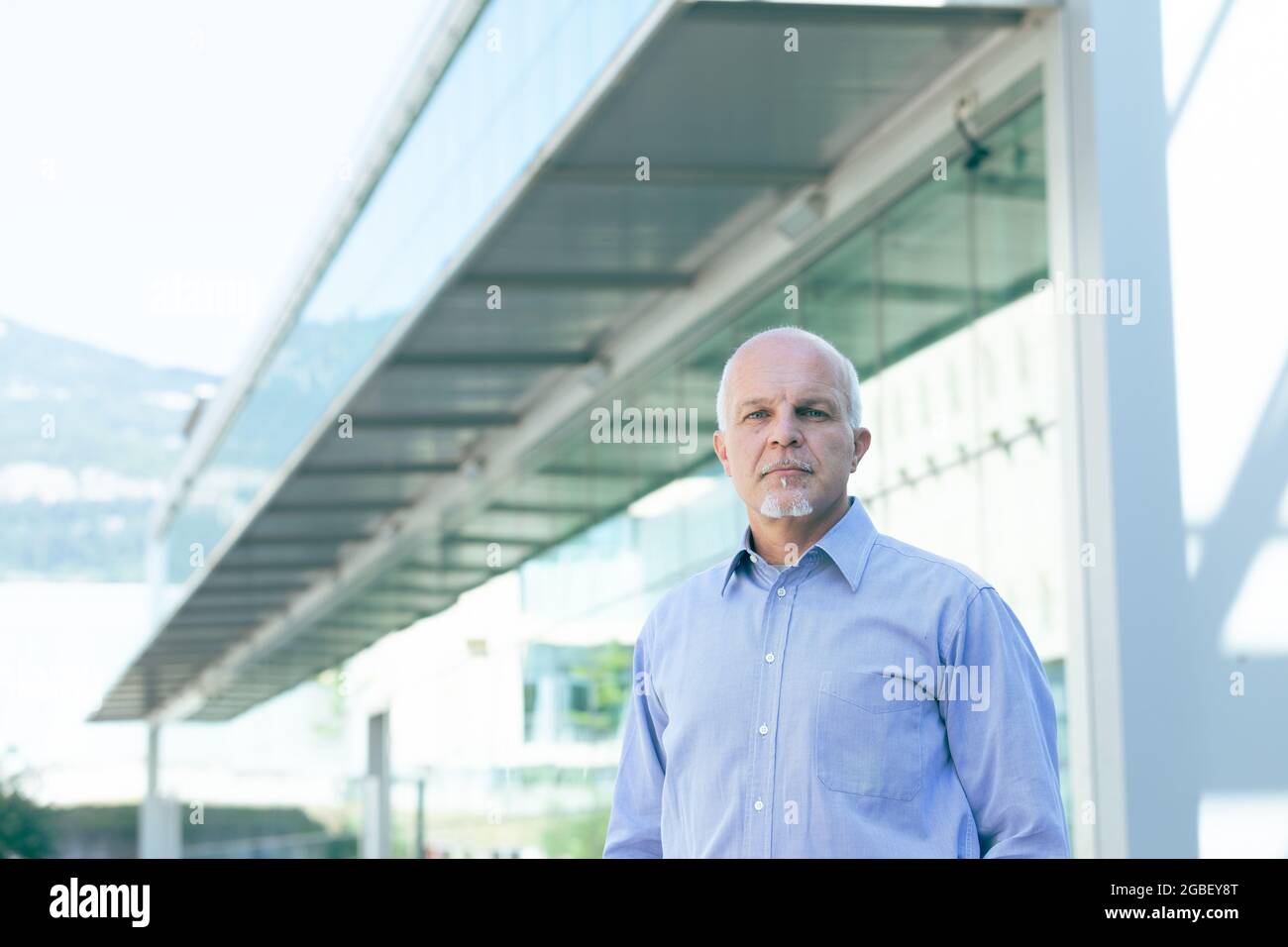 Serious businessman with inscrutable stare looking intently at the ...