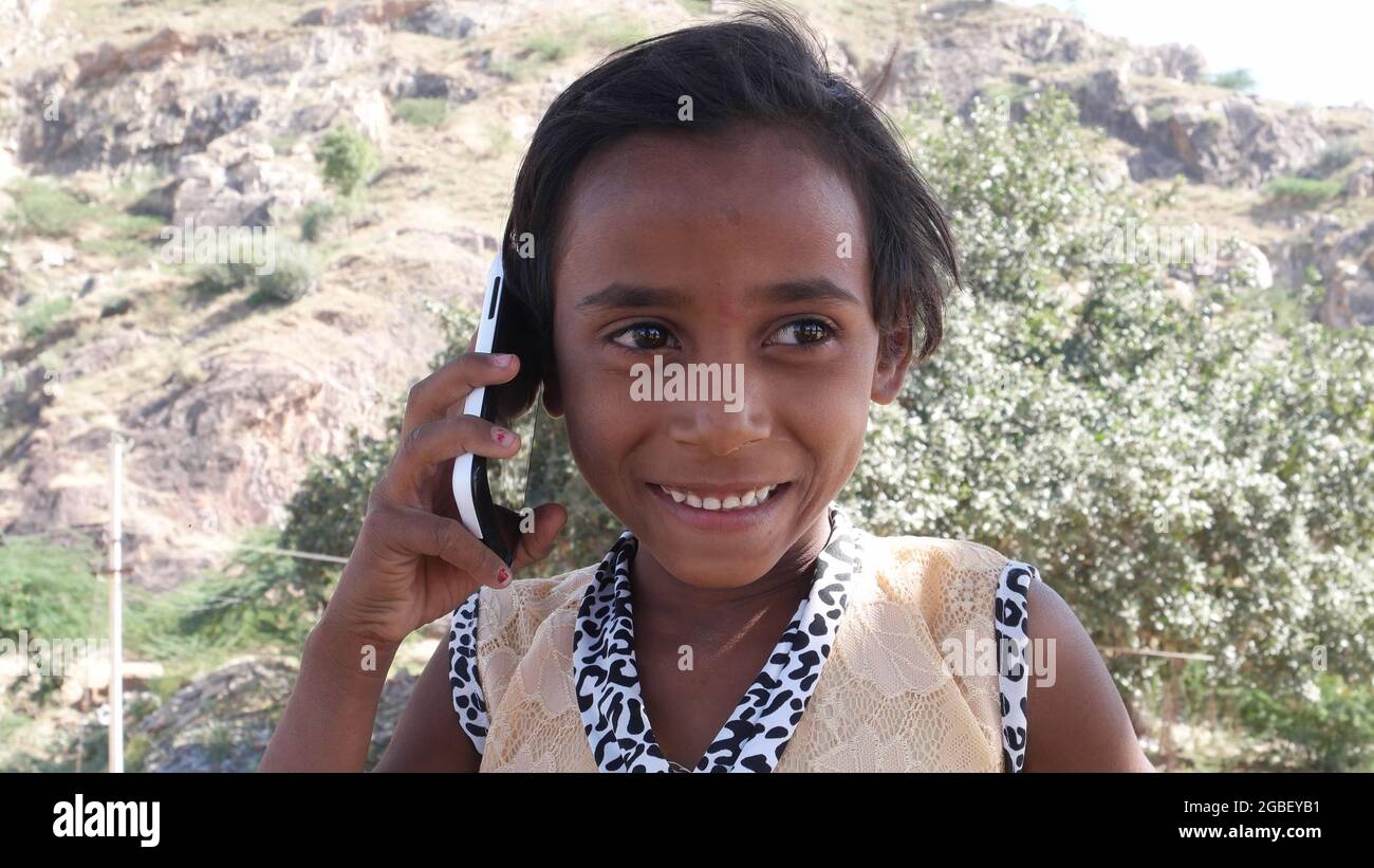 Cute happy kid talking on the phone Stock Photo - Alamy