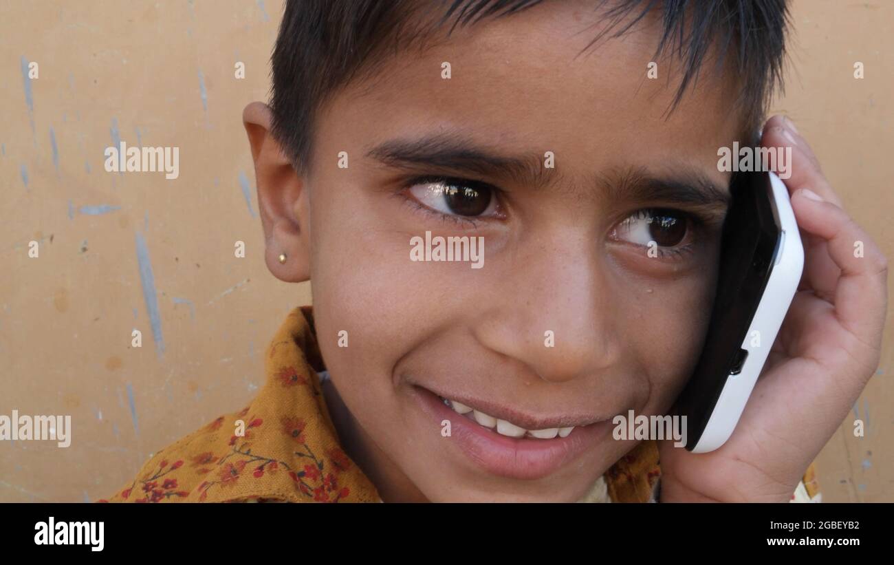 Cute happy kid talking on the phone Stock Photo - Alamy