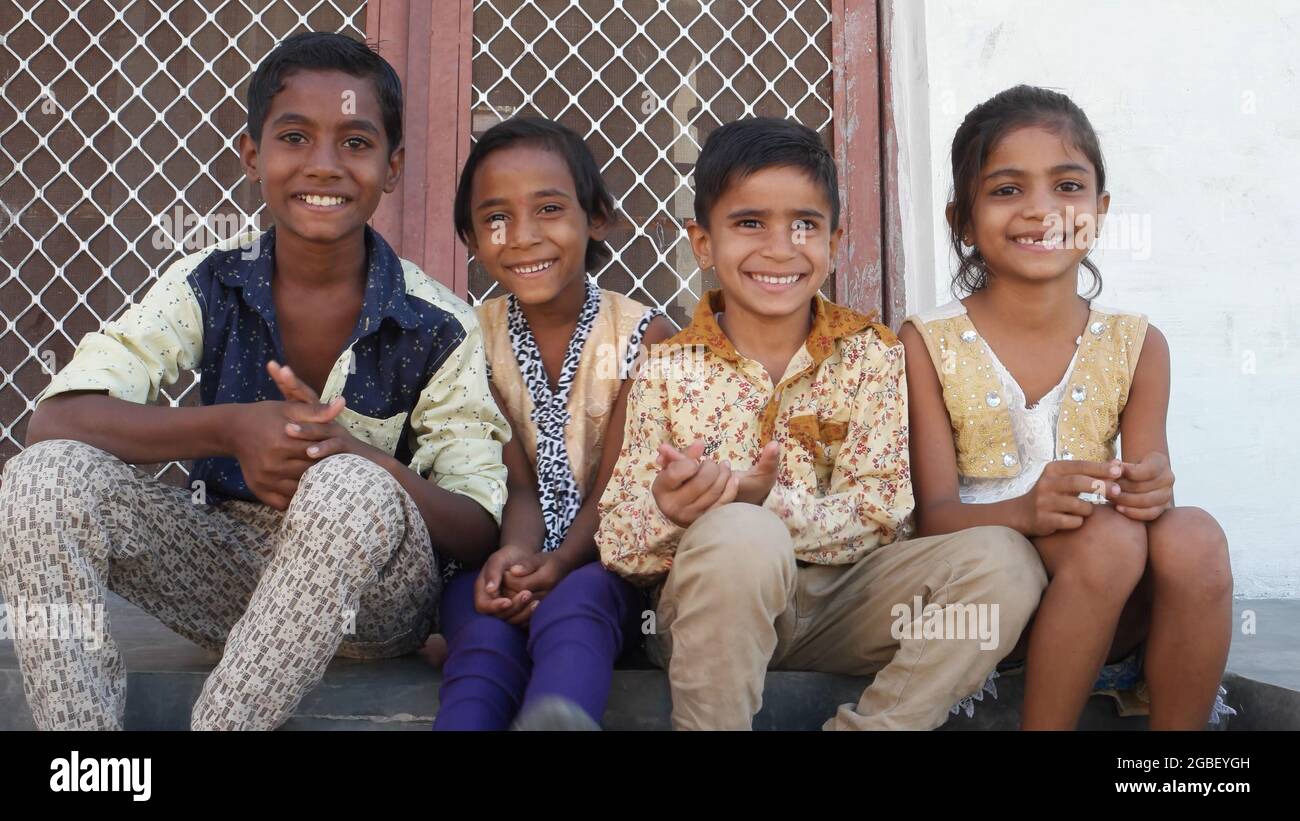 Happy children sitting together outdoor Stock Photo - Alamy