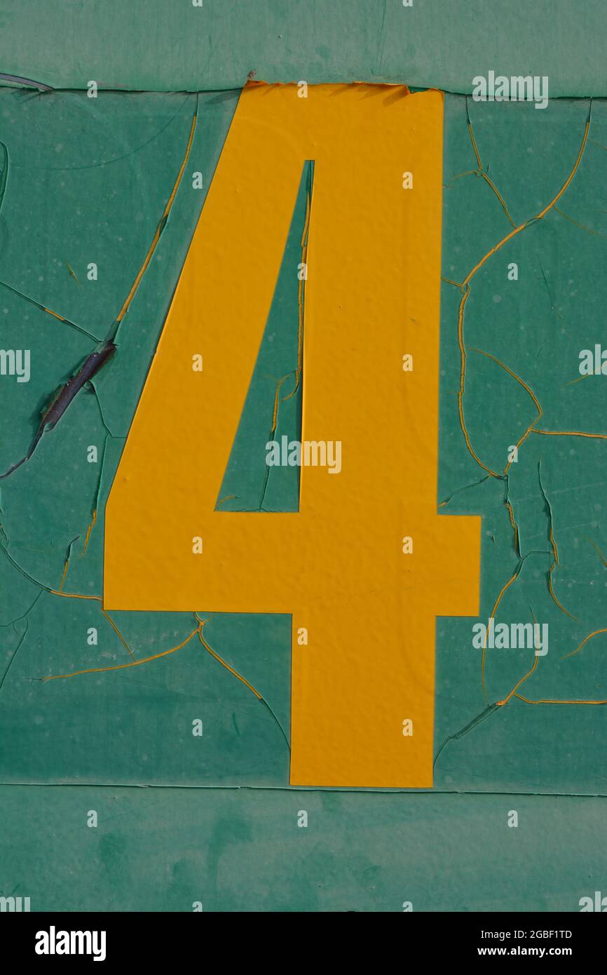 Yellow number four on a green cracked background Stock Photo - Alamy