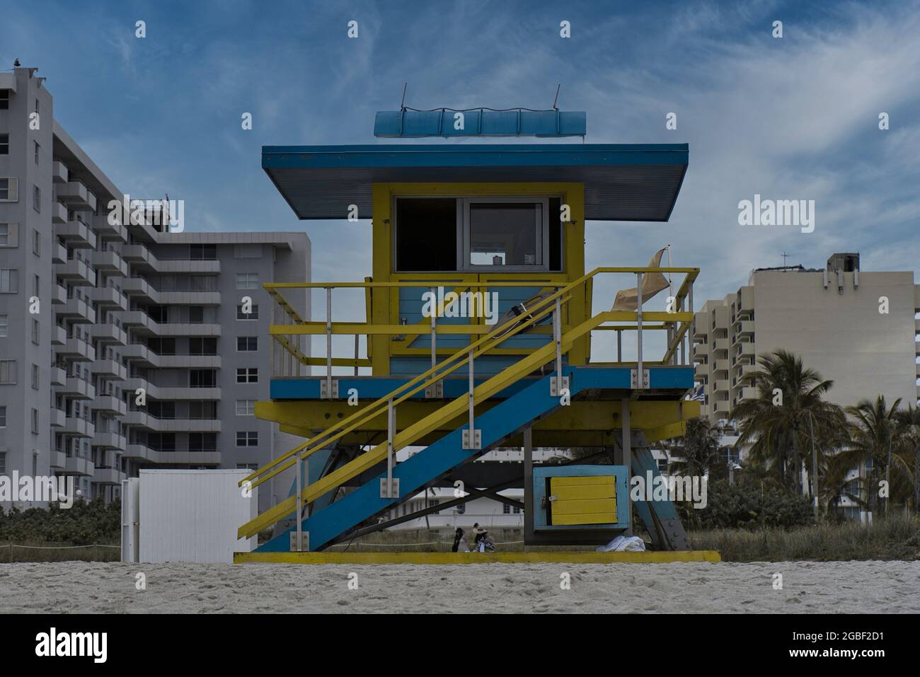 Shot of a blue and yellow beach lifeguard rescue station under the blue ...