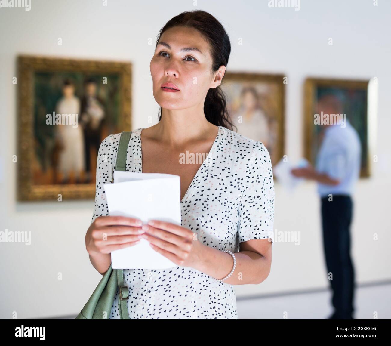 woman admiring art work Stock Photo - Alamy