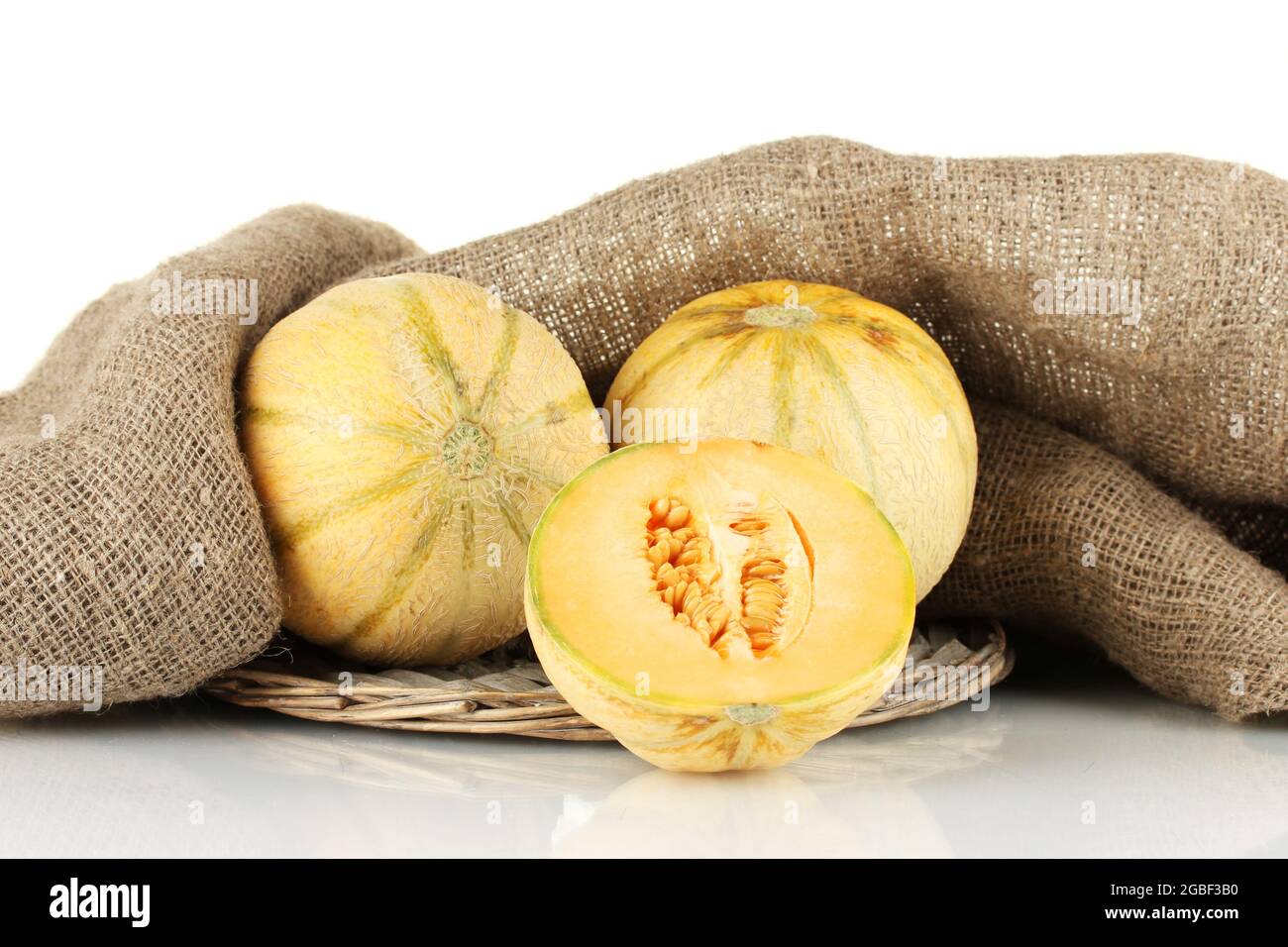 cut melon on wicker mat on sackcloth background close up Stock Photo ...