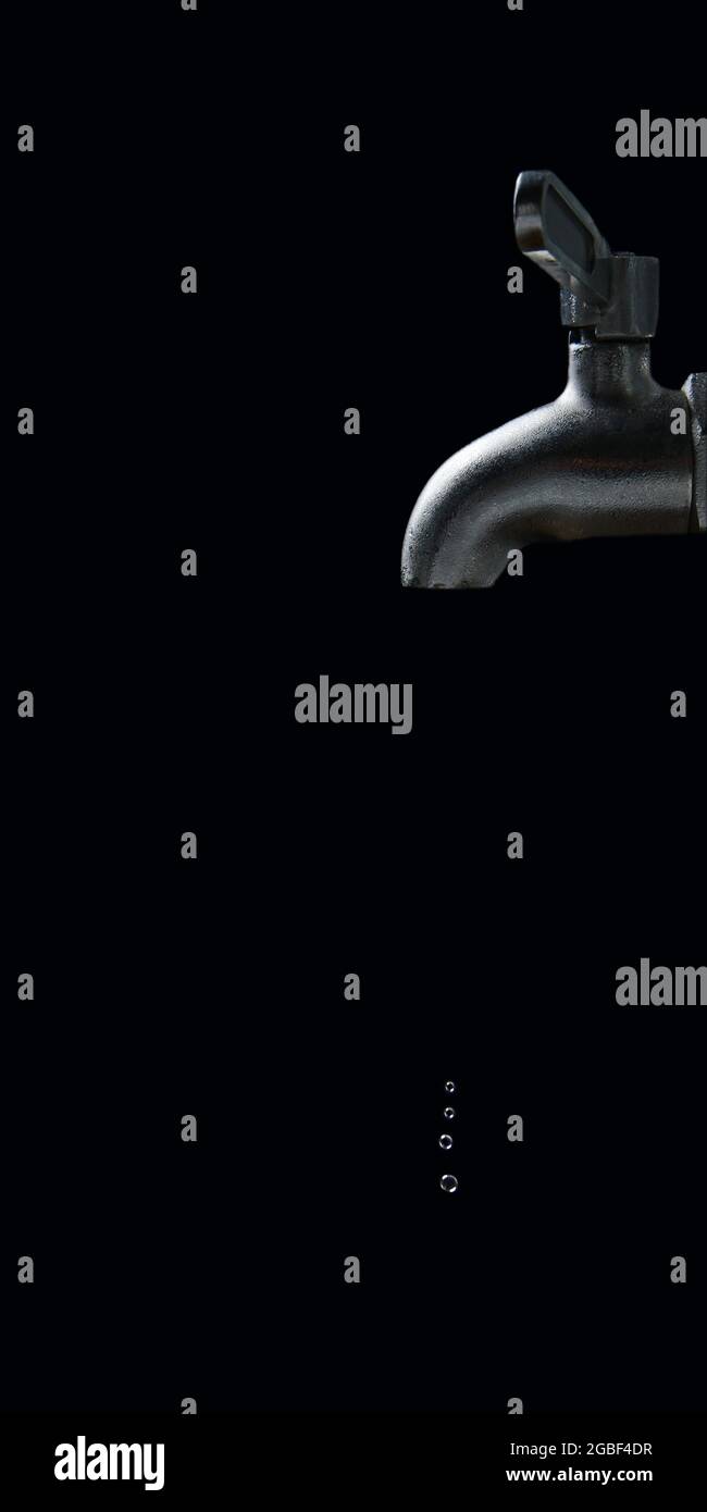 Vintage Spigot and water on black background Stock Photo - Alamy