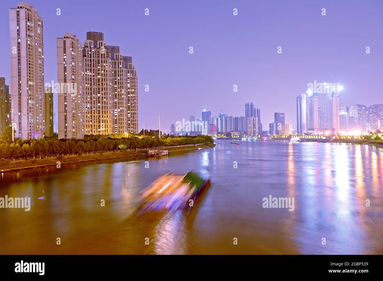 WUHAN, CHINA - AUGUST 3, 2021 - Night view of the riverside high-rise ...