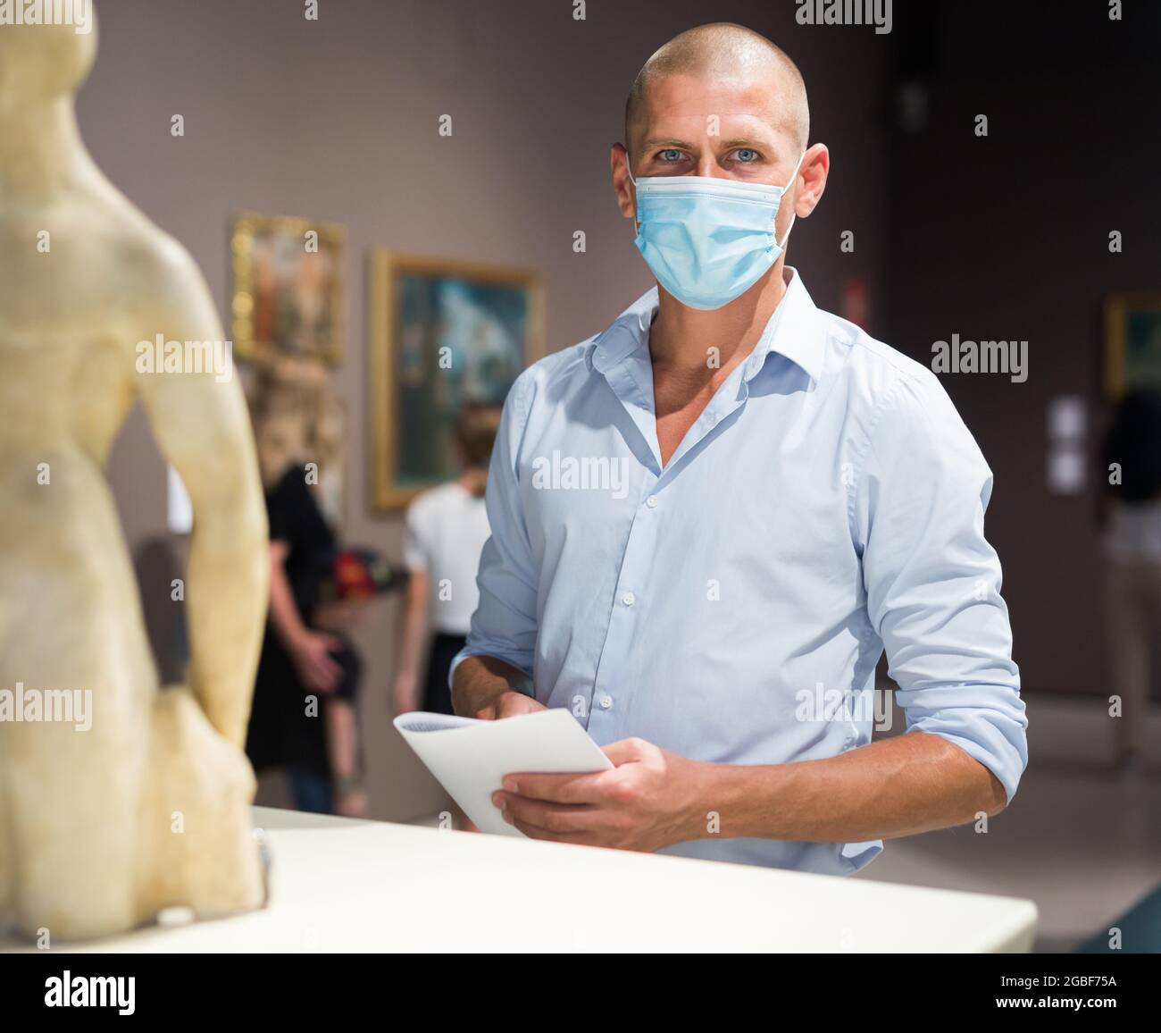 Man standing in museum hall Stock Photo - Alamy