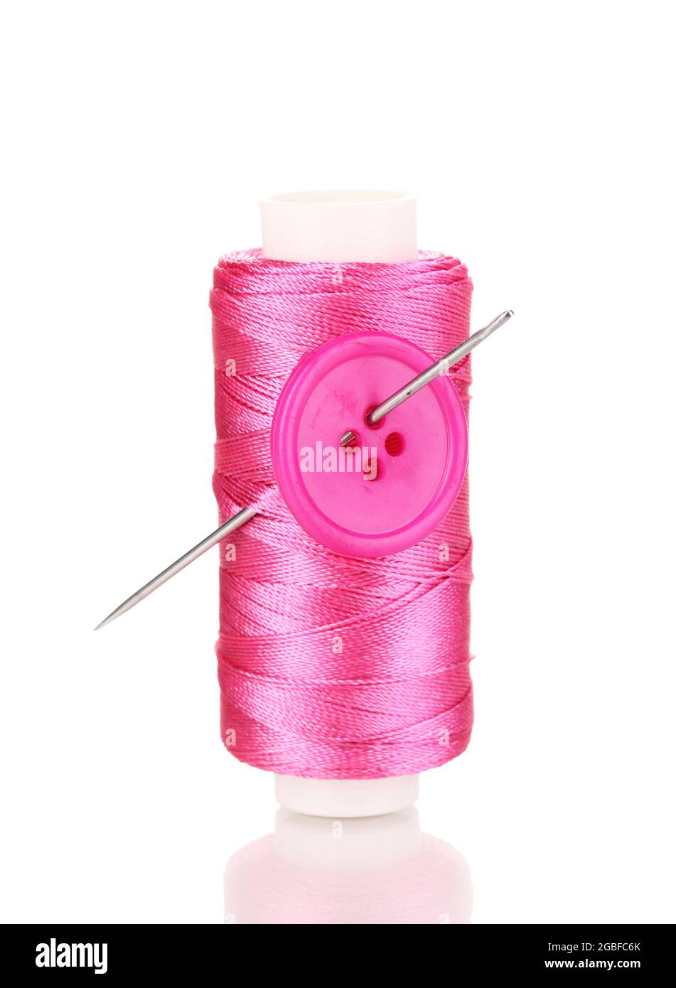 Pink bobbin with needle and buttons isolated on white Stock Photo - Alamy