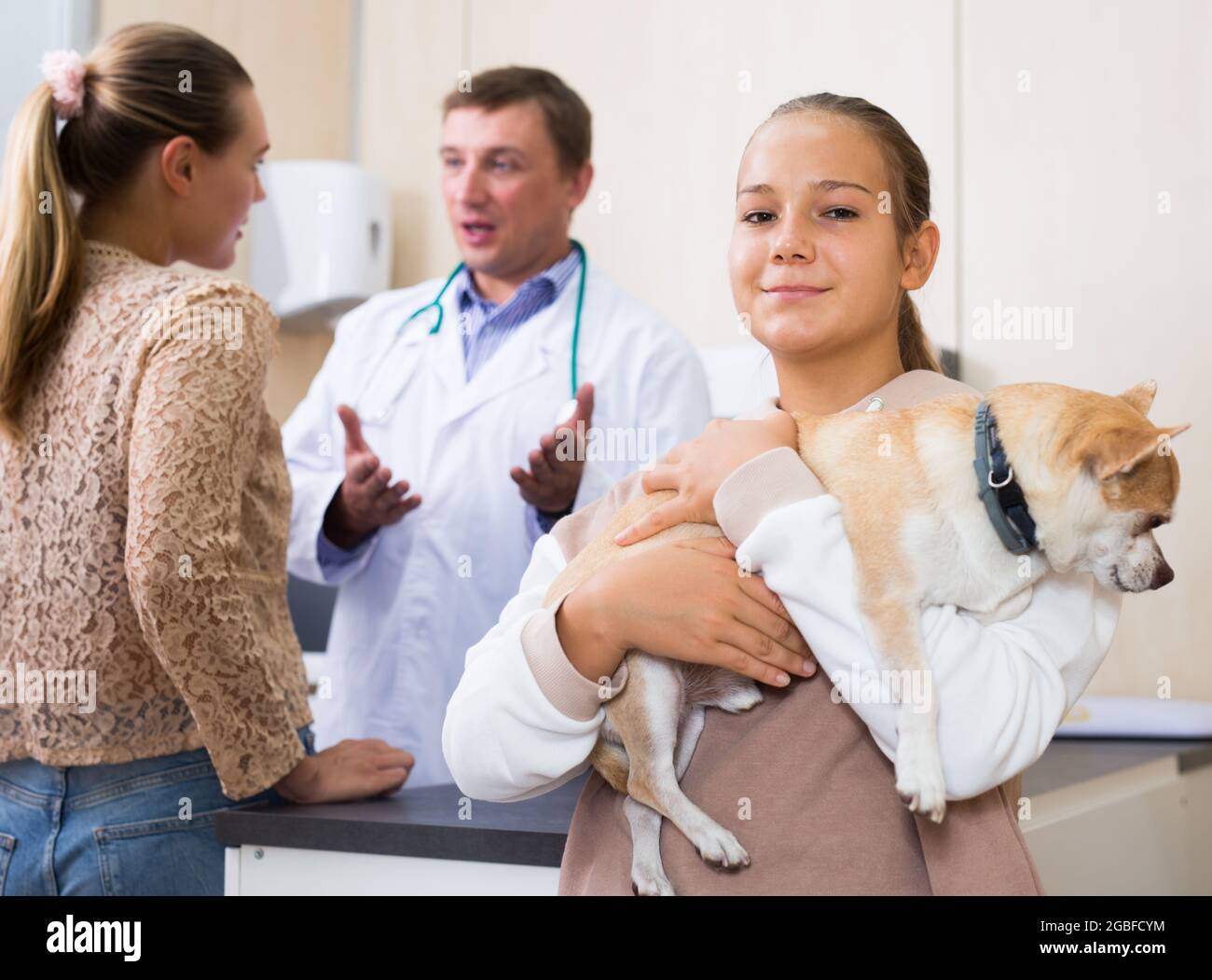 Teenager girl bringing a puppet dog at medical office Stock Photo - Alamy