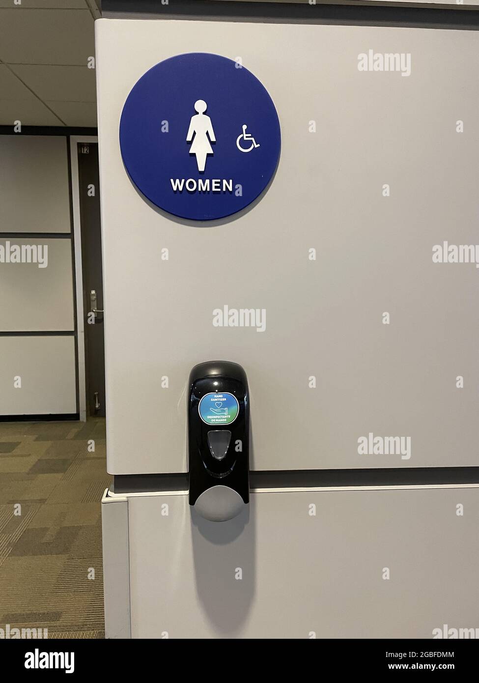 Female bathroom sign and a sanitizer dispenser Stock Photo - Alamy