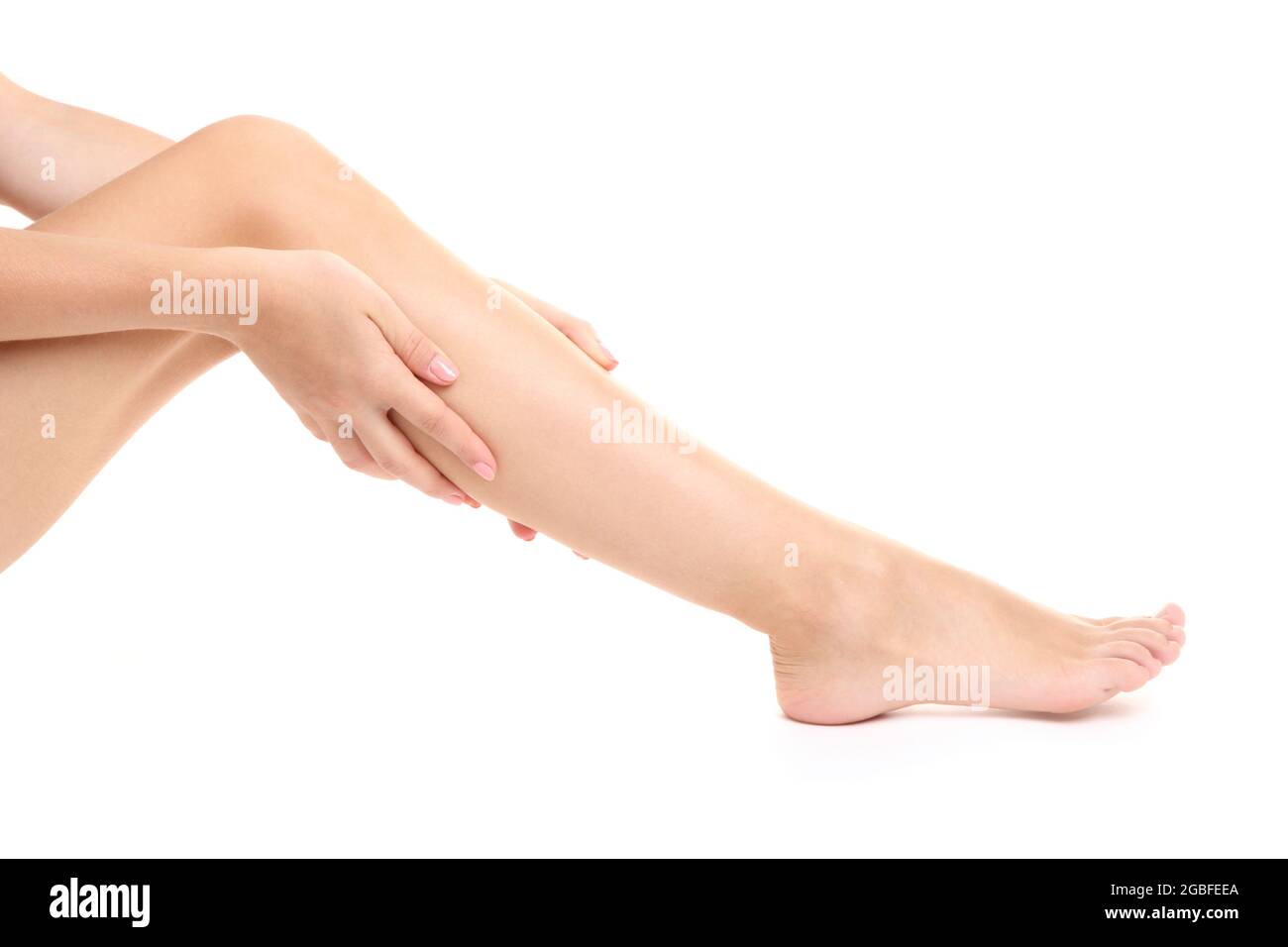 woman holding sore leg, isolated on white Stock Photo - Alamy