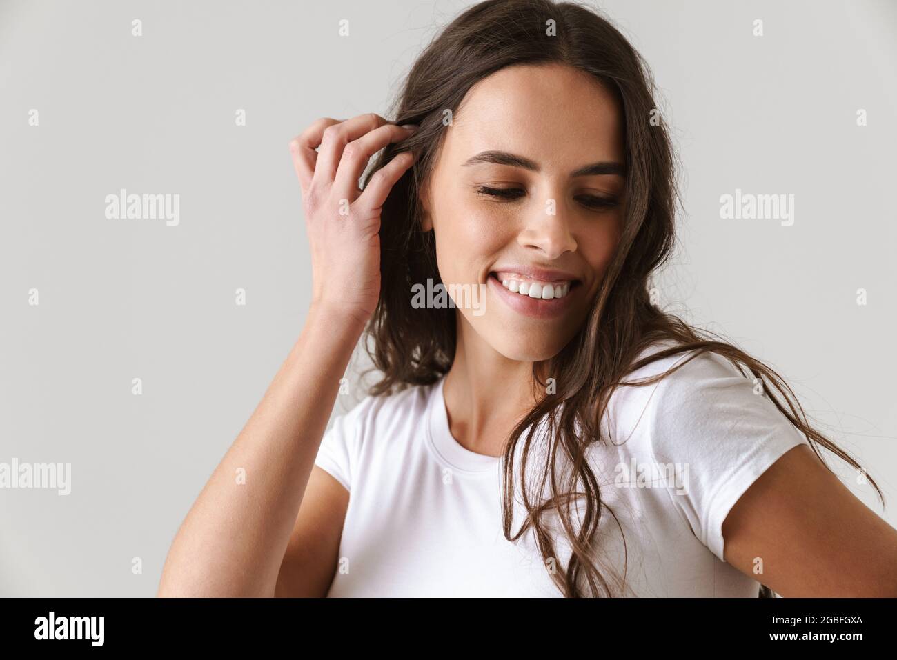 Happy beautiful girl posing and smiling at camera isolated over white ...