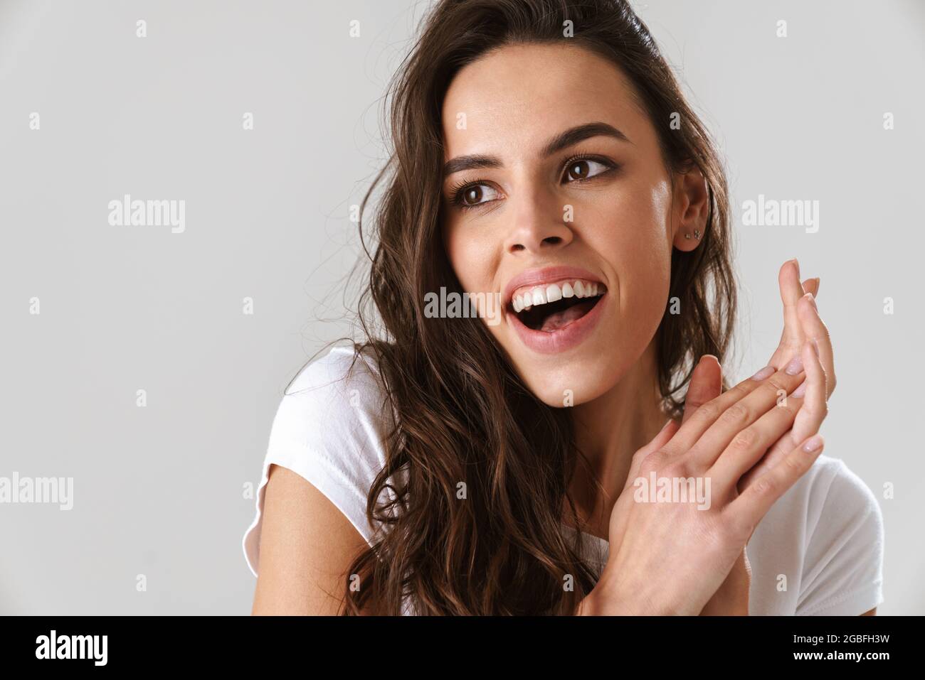 Happy beautiful girl expressing surprise on camera isolated over white ...