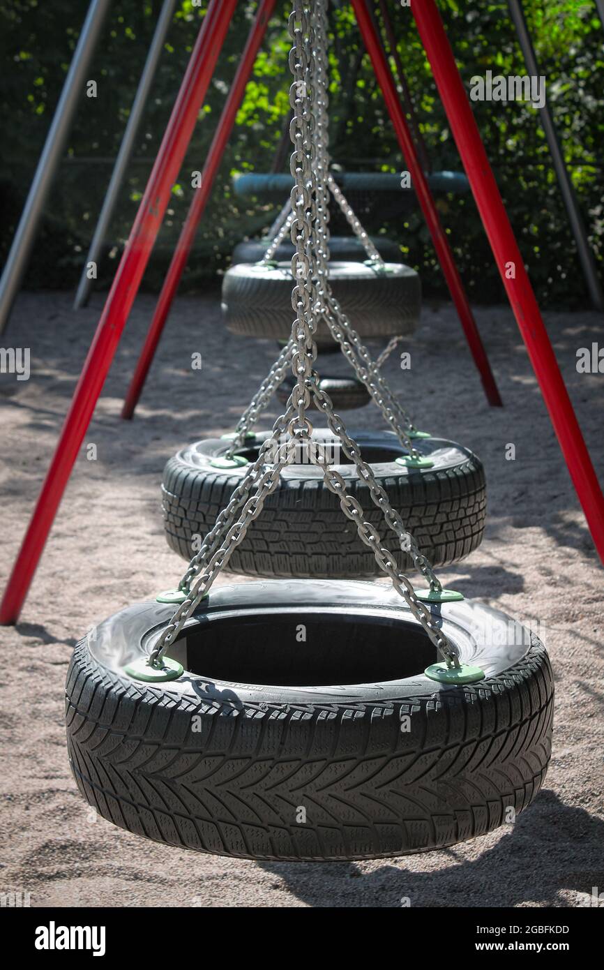 Swing made with car tires in the playground Stock Photo - Alamy
