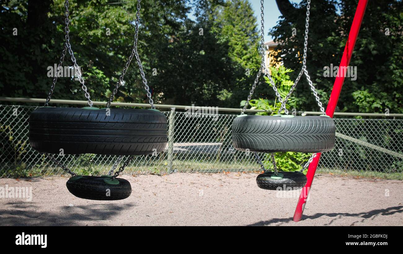 Swing made with car tires in the playground Stock Photo - Alamy