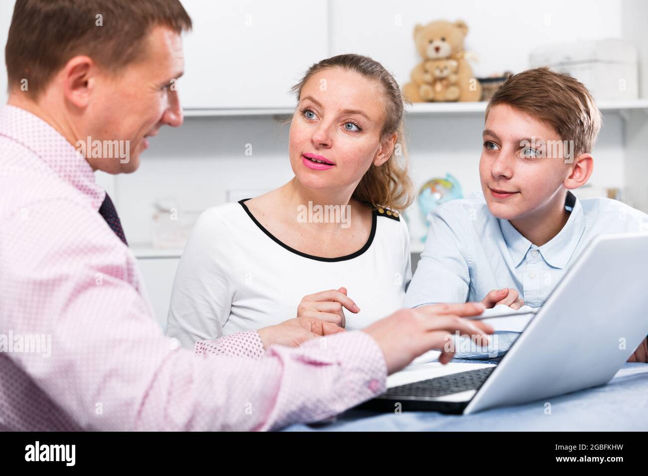 Mother and son signing documents Stock Photo - Alamy