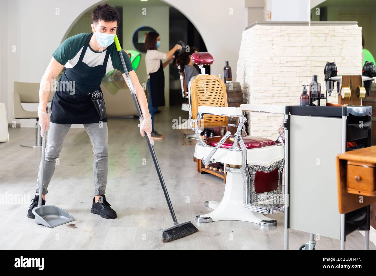 Barber cleaning floor hairdresser salon hi-res stock photography and ...
