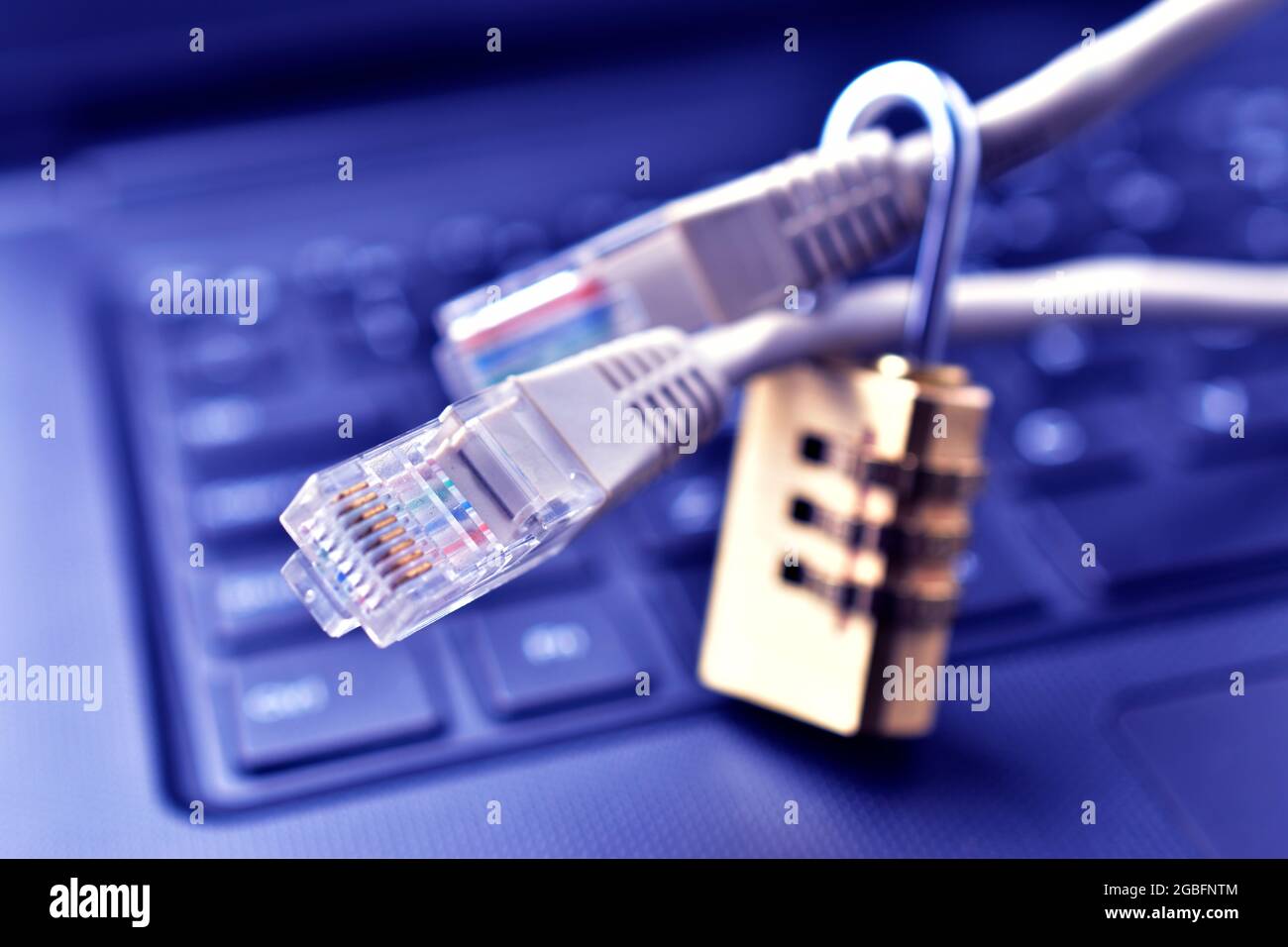 Cyber safety concept, lock and internet cable on laptop computer ...