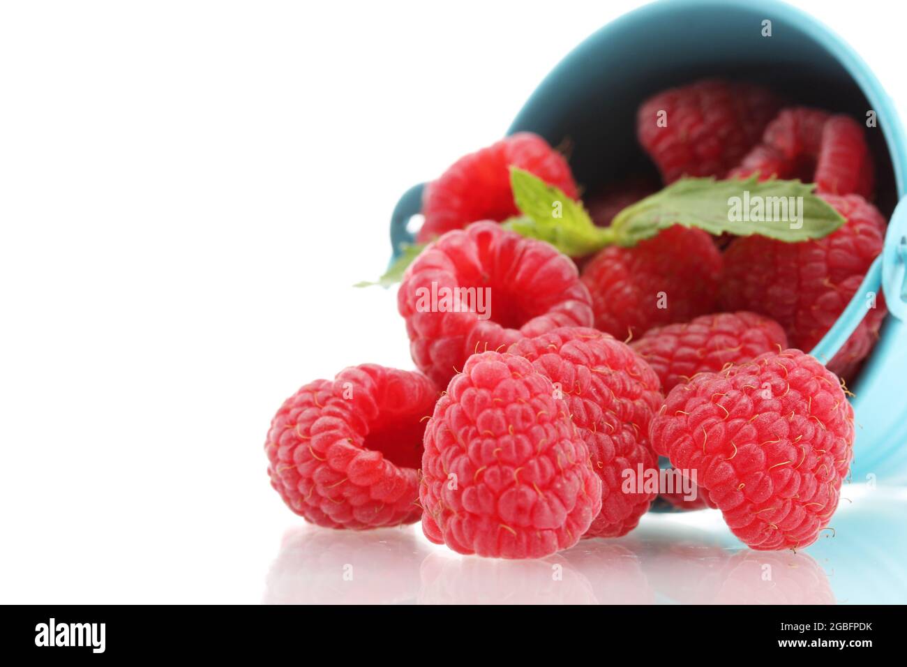 beautiful raspberries in bucket isolated on white Stock Photo - Alamy
