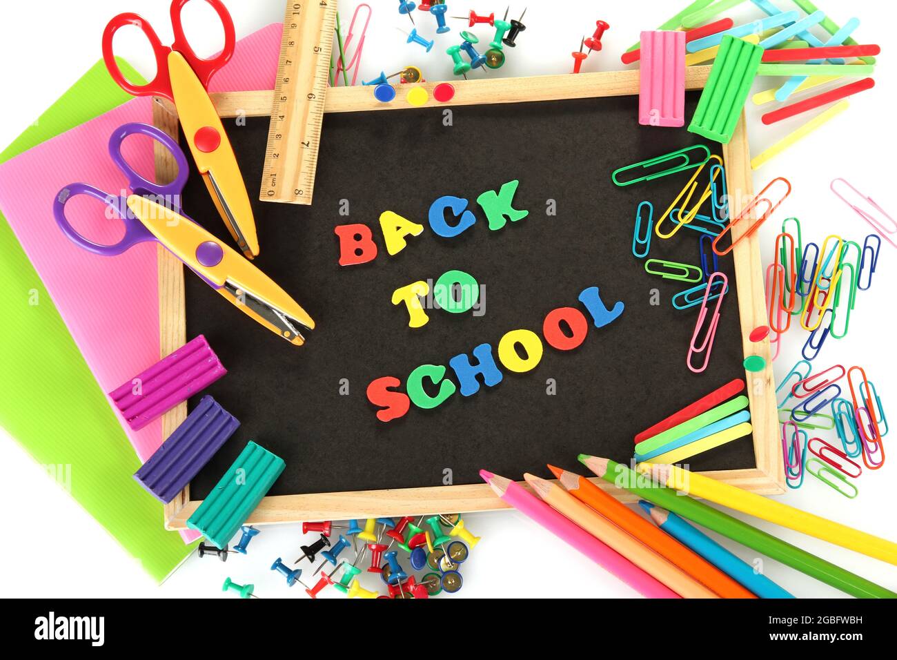 Small chalkboard with school supplies on white background. Back to ...
