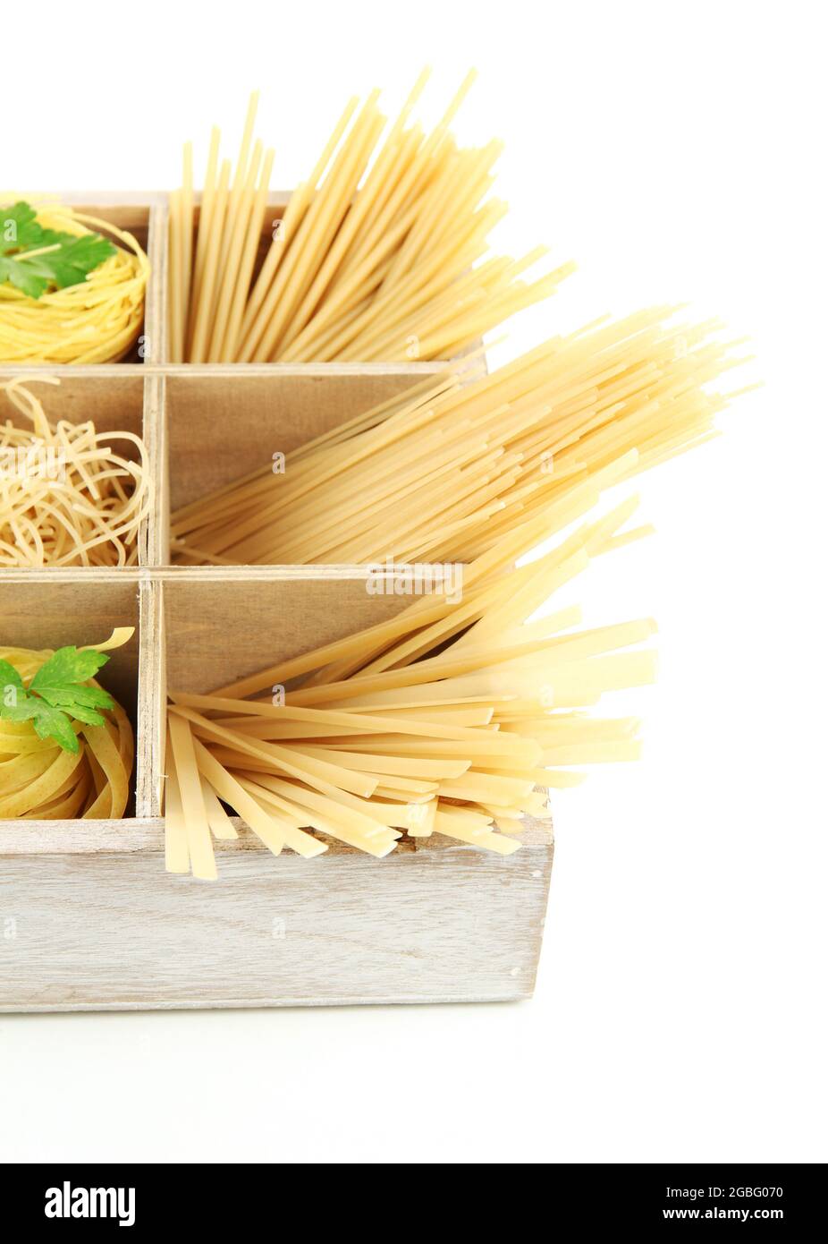 Nine types of pasta in wooden box sections close-up isolated on white ...