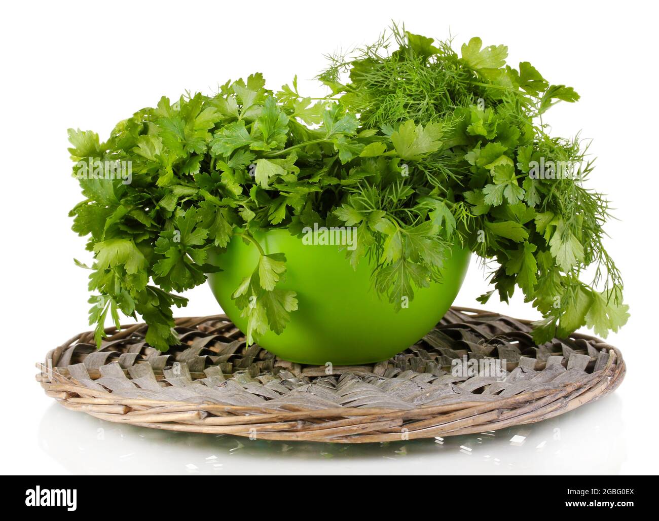 Green pot with parsley and dill on wicker cradle isolated on white ...