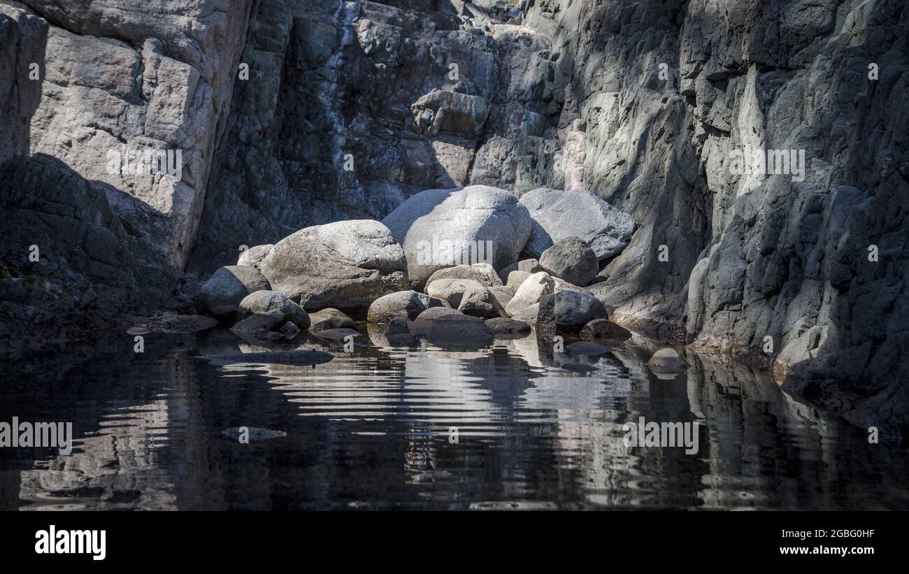 Bunch of gray rocks and tones in the water Stock Photo - Alamy