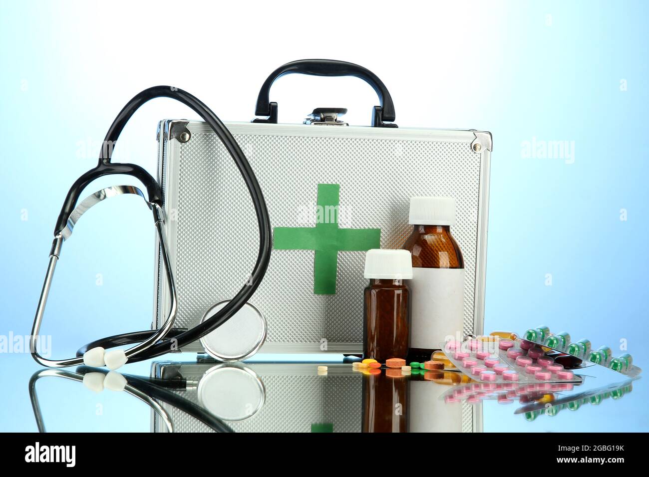 First aid box, on blue background Stock Photo - Alamy