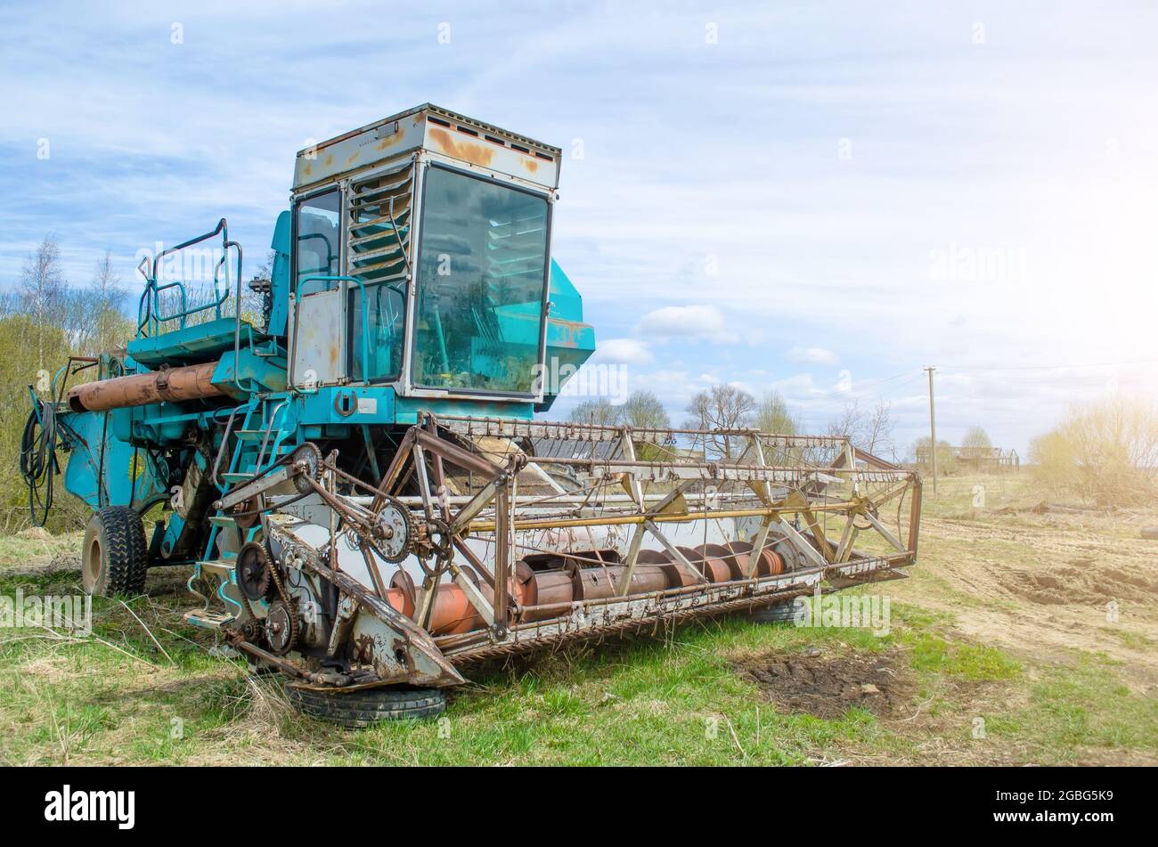 Old rusty combine harvester equipment in an abandoned collective farm ...