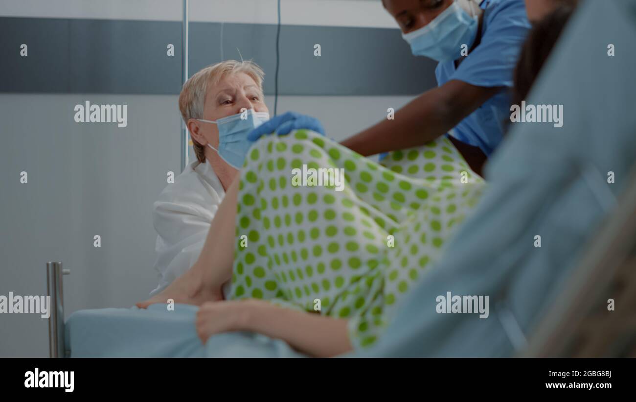 Obstetrics doctor delivering baby for caucasian woman in hospital ward ...