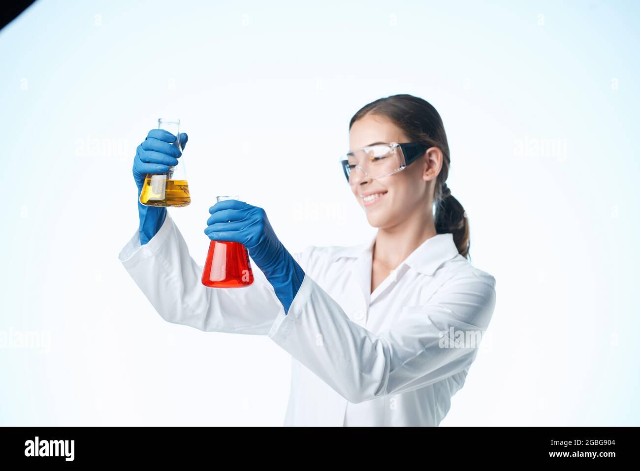 Female laboratory assistant in a white coat chemical solution ...