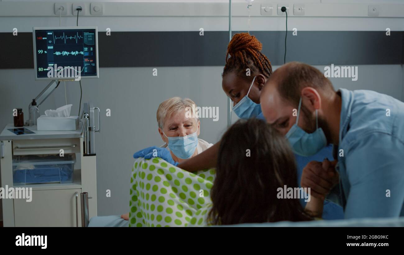 Caucasian family in childbirth labor getting medical assistance in ...